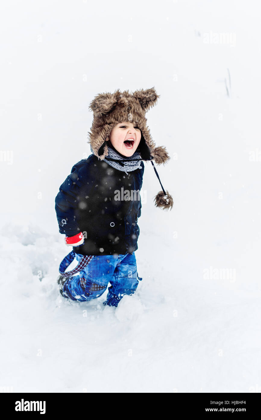 Boy having fun in the snow Stock Photo - Alamy