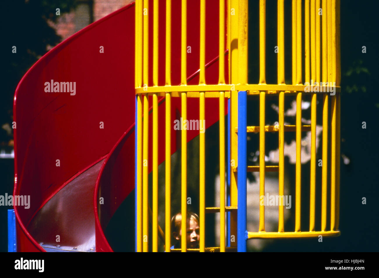 Young child on steps to children's slide Stock Photo - Alamy