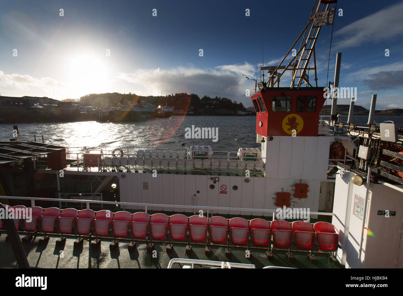 Town of Oban, Scotland. Silhouetted view of a Cal Mac ferry berthed at ...