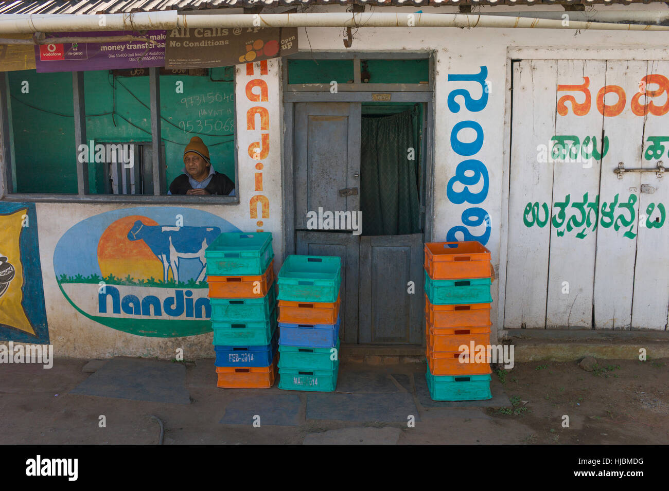 roadside shop with shopkeeper in Byalkuppe India Stock Photo - Alamy