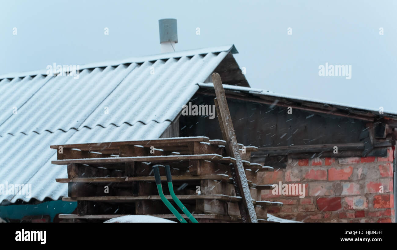 Cart rusty barrel and a stack of wooden pallets in the winter Stock ...