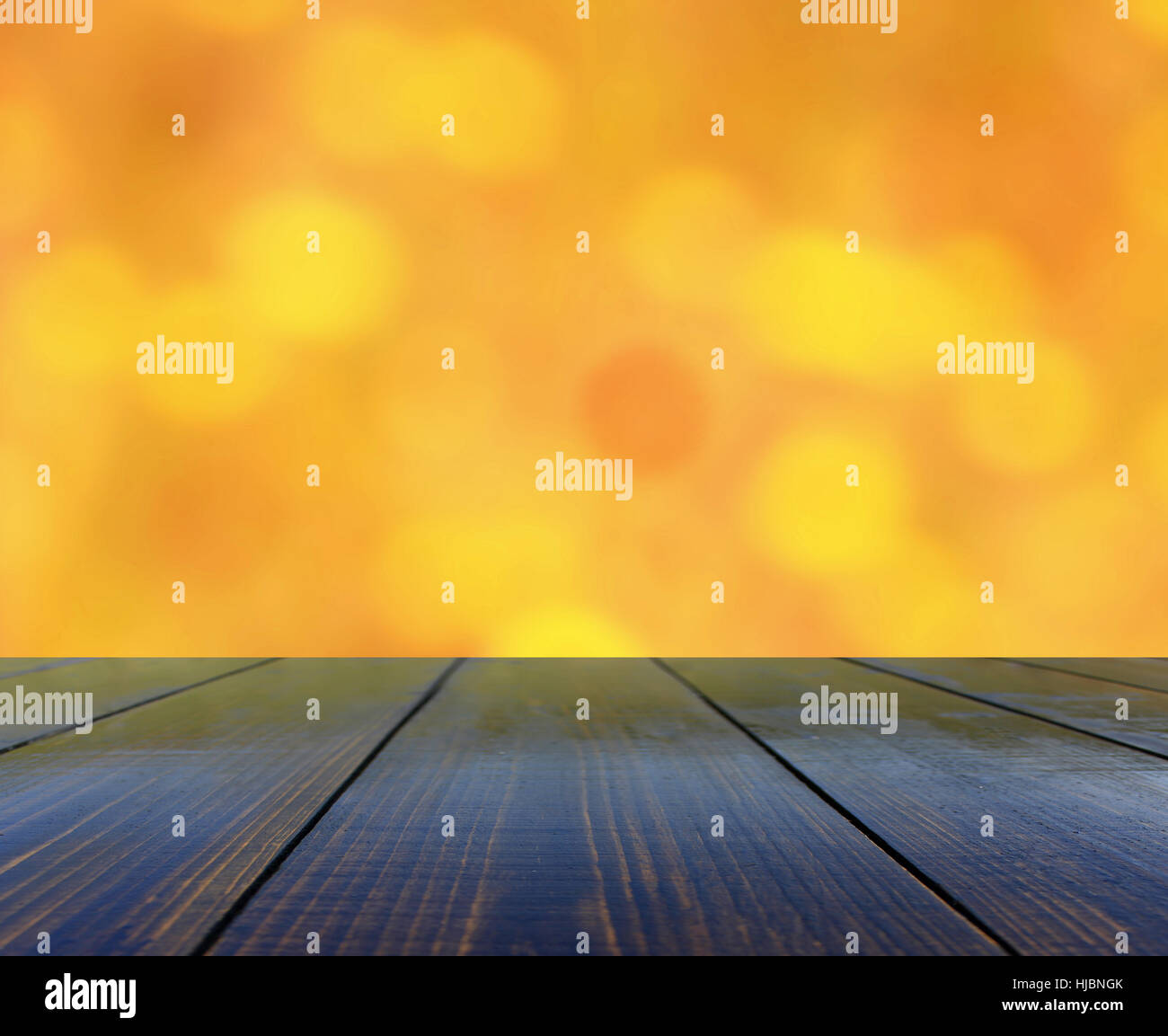 table from wooden boards with blurred brown background with yellow ...