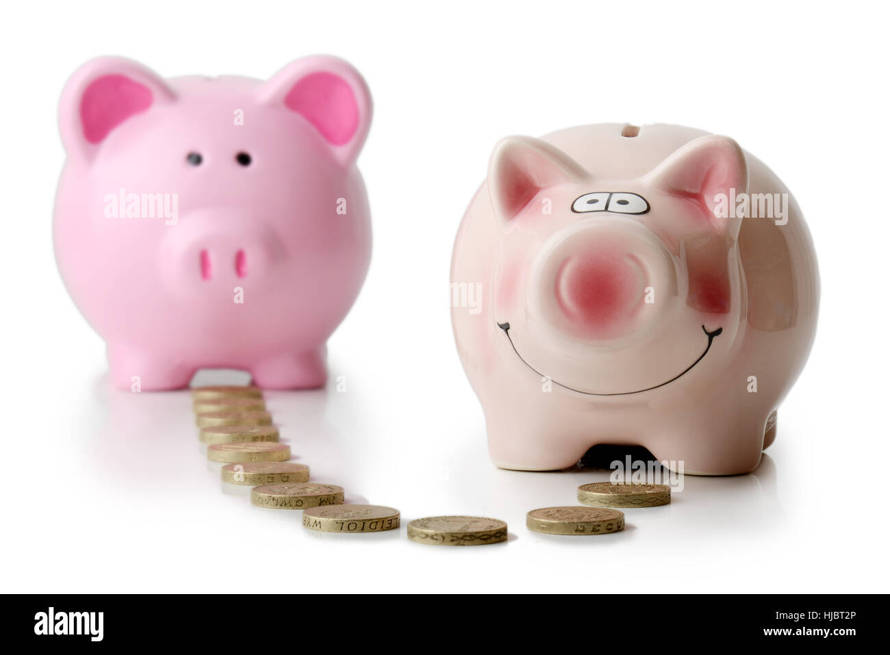 two piggy banks with money transfer concept isolated on a white ...