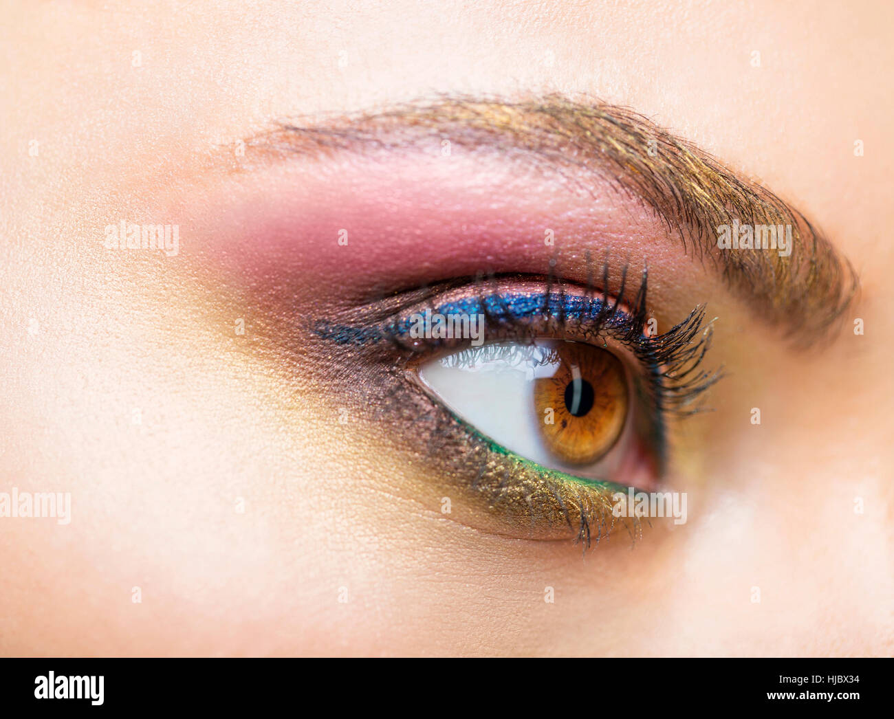 Close up portrait of a beautiful young blond model with bright make up ...