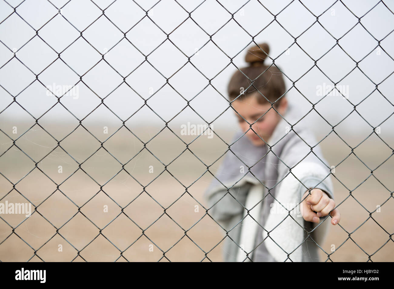 Portrait of a girl behind a fence hi-res stock photography and images ...