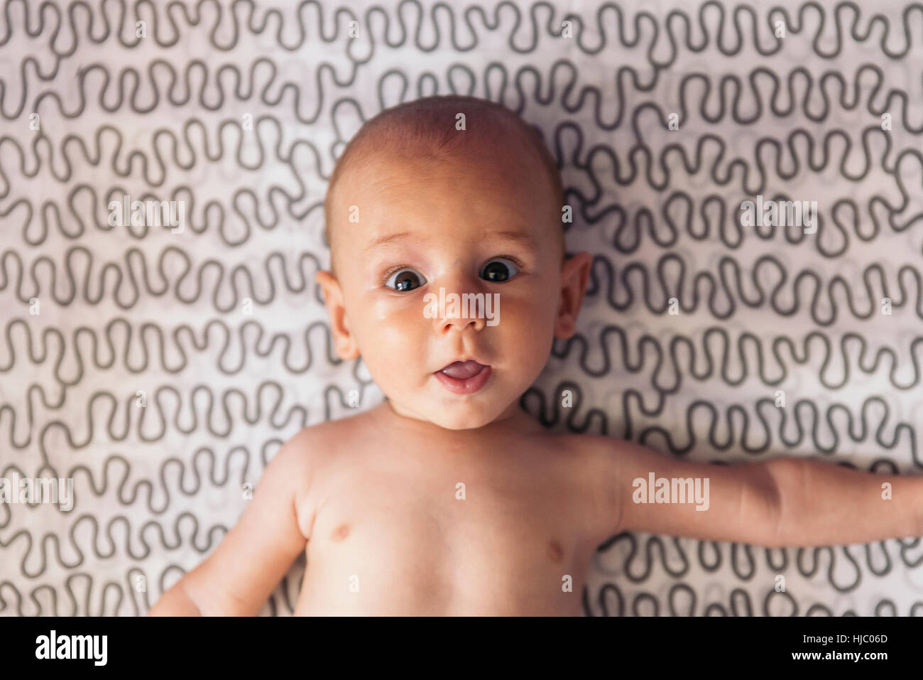 Beautiful expressive baby in the bed Stock Photo - Alamy