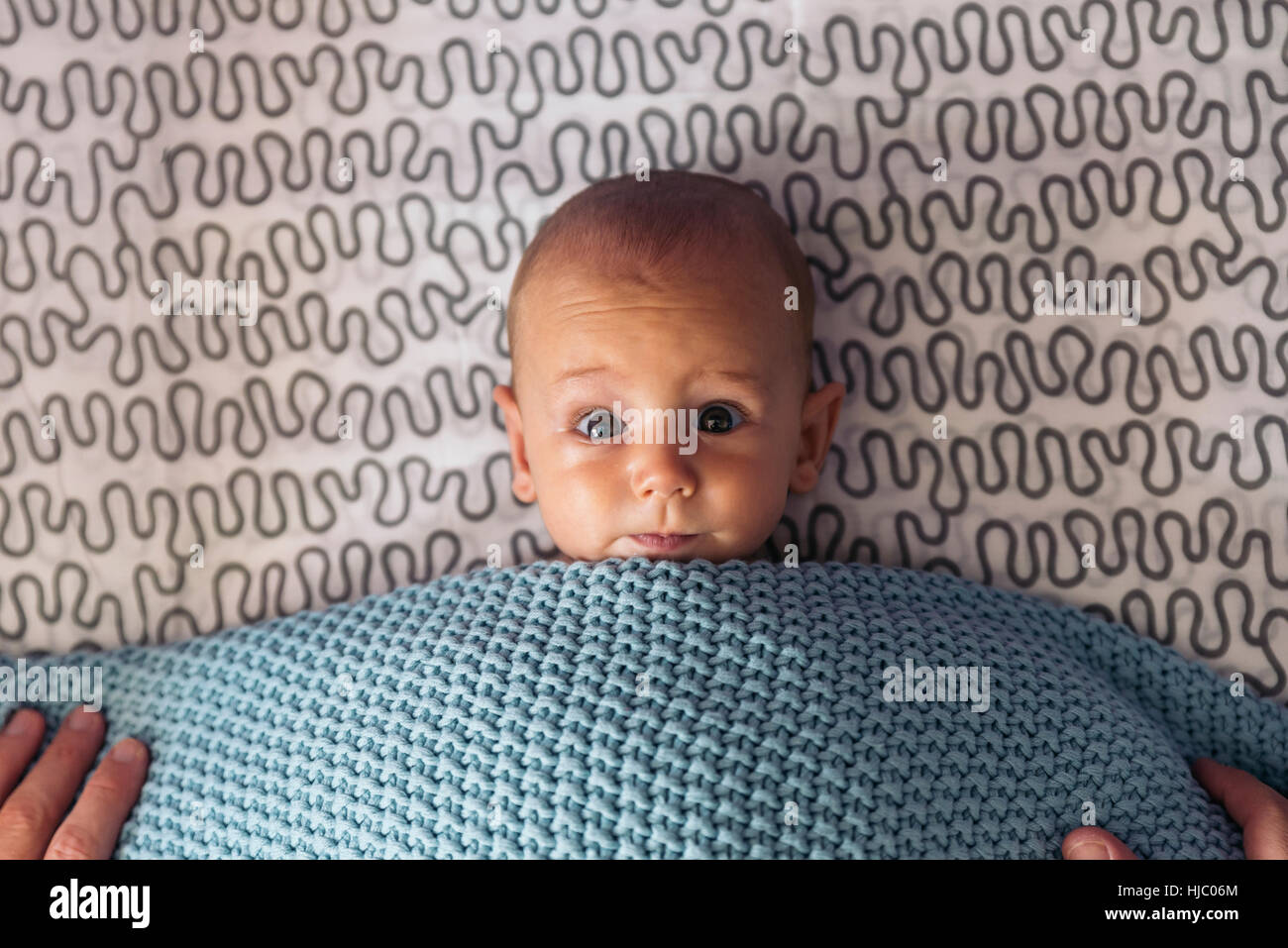 Beautiful expressive baby in the bed Stock Photo - Alamy