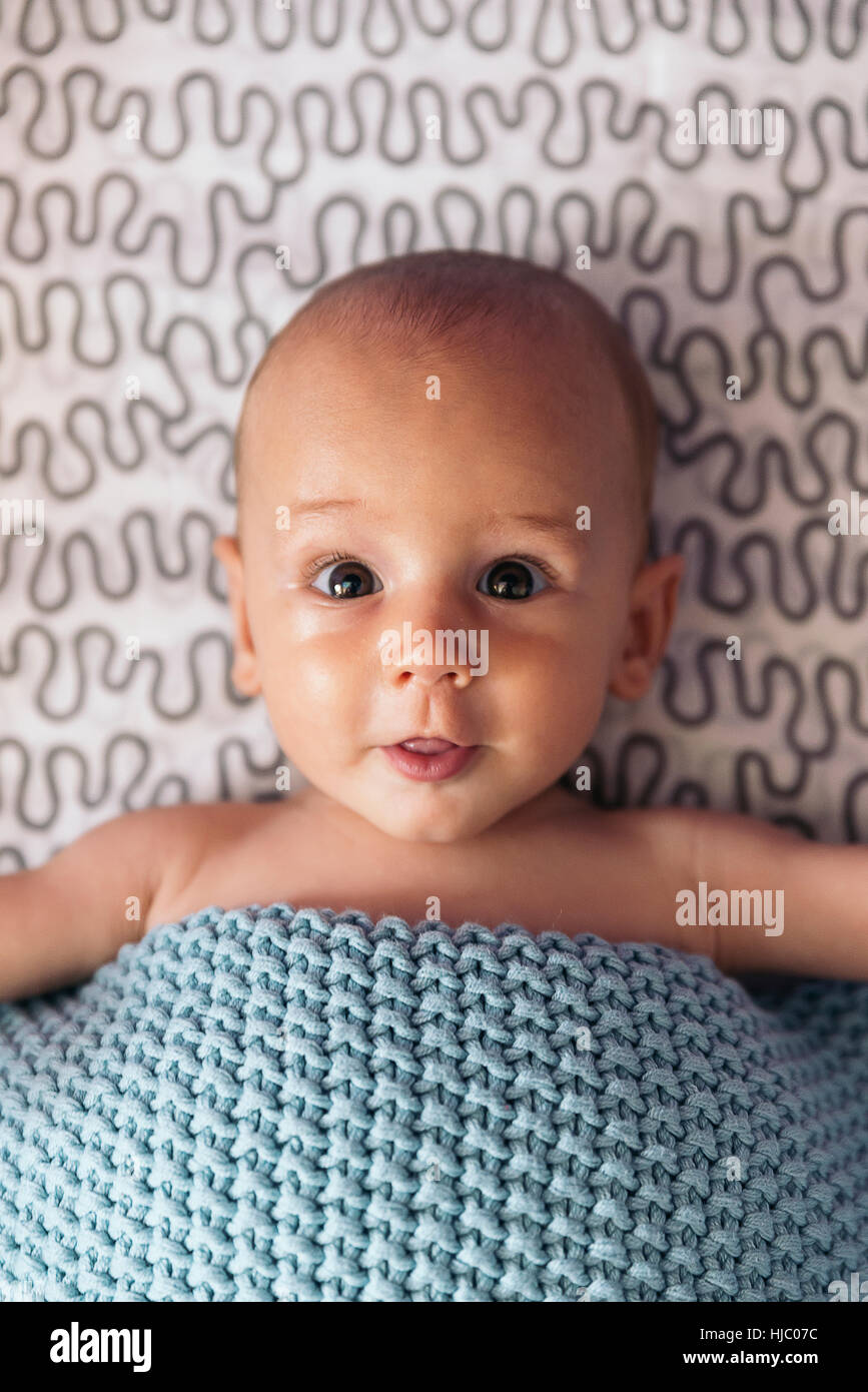 Beautiful expressive baby in the bed Stock Photo - Alamy