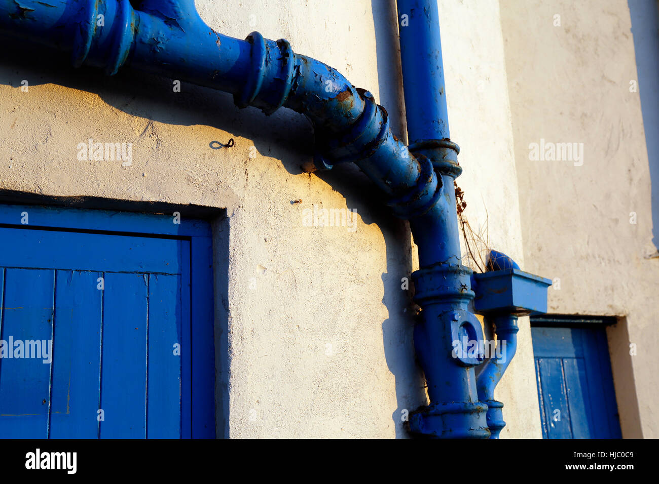 Blue drain with plant growing hi-res stock photography and images - Alamy