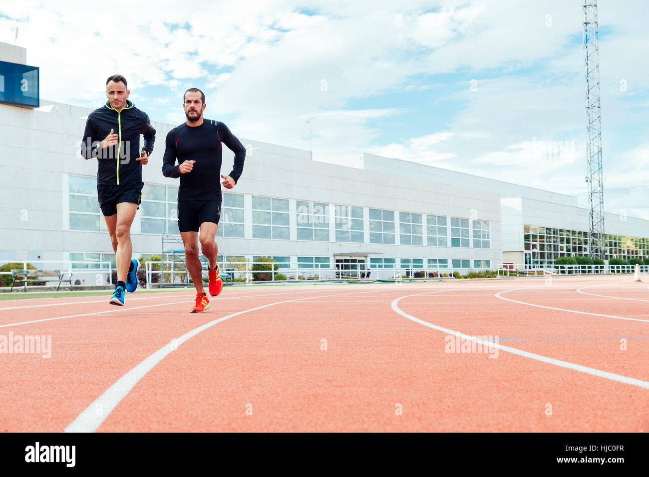 Group of young athletics people running on the track field Stock Photo ...