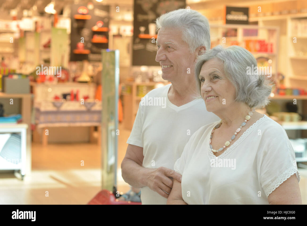 Portrait of beautiful elderly couple in shopping mall Stock Photo - Alamy