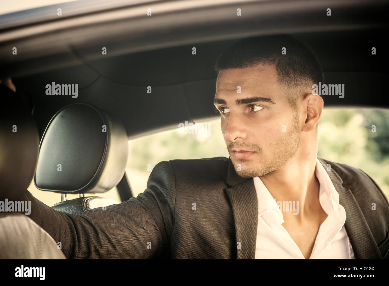 Handsome Young Man Driving a Car Stock Photo - Alamy
