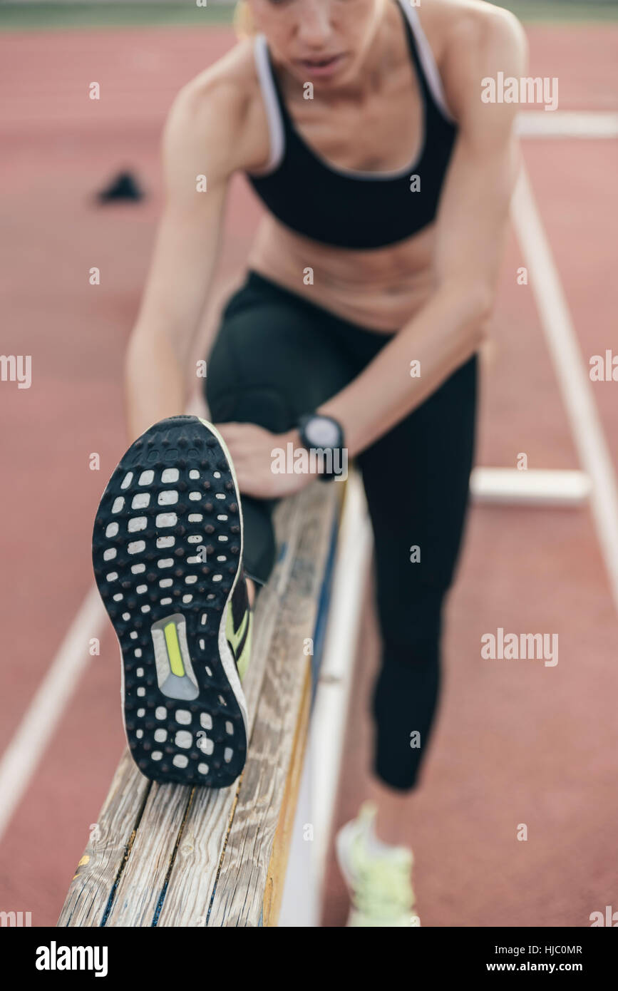 Runner Stretching in the trackrace After Workout Stock Photo - Alamy