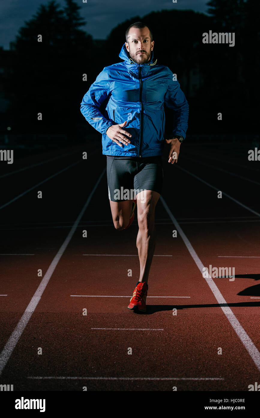 Attractive man Track Athlete Running On Track looking camera Stock ...