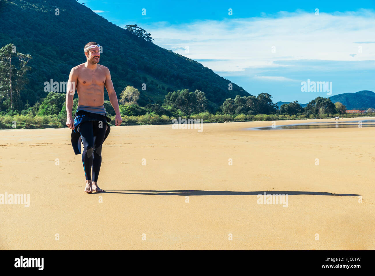 Handsome Swimmer ready to start swimming on the beach Stock Photo - Alamy
