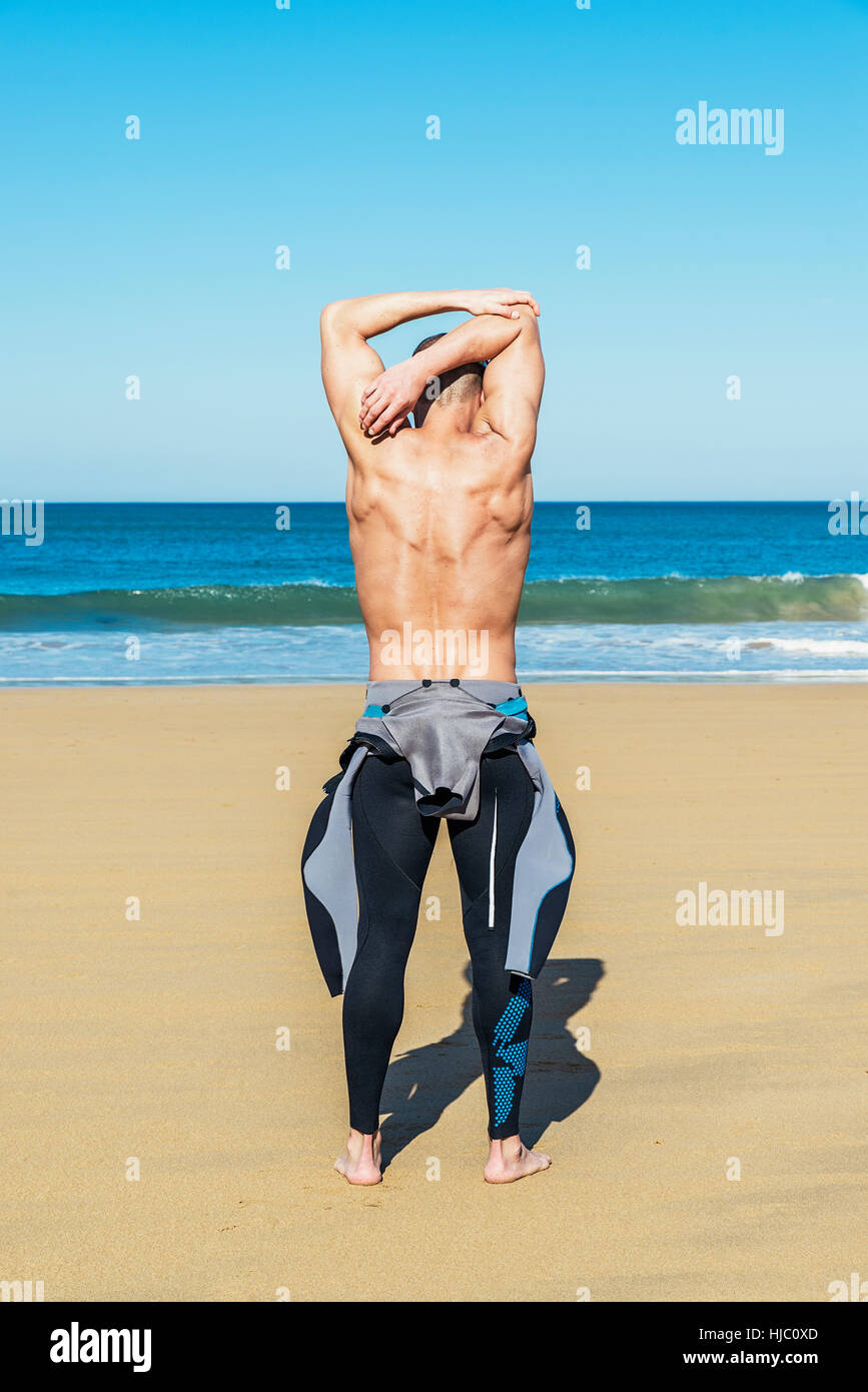 fitness man swimmer training stretching on the beach Stock Photo - Alamy