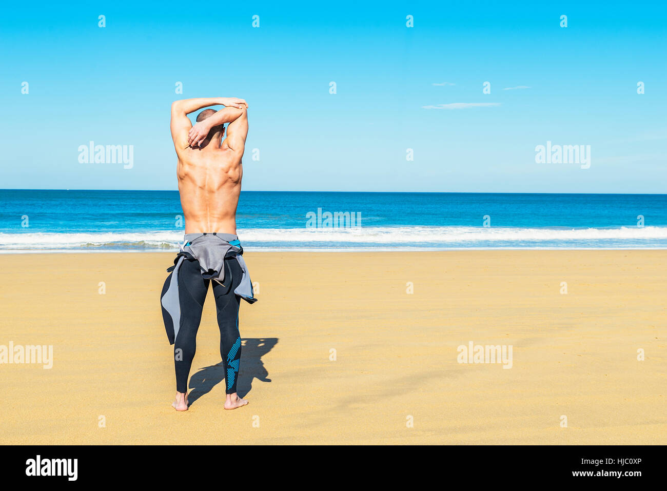 fitness man swimmer training stretching on the beach Stock Photo - Alamy