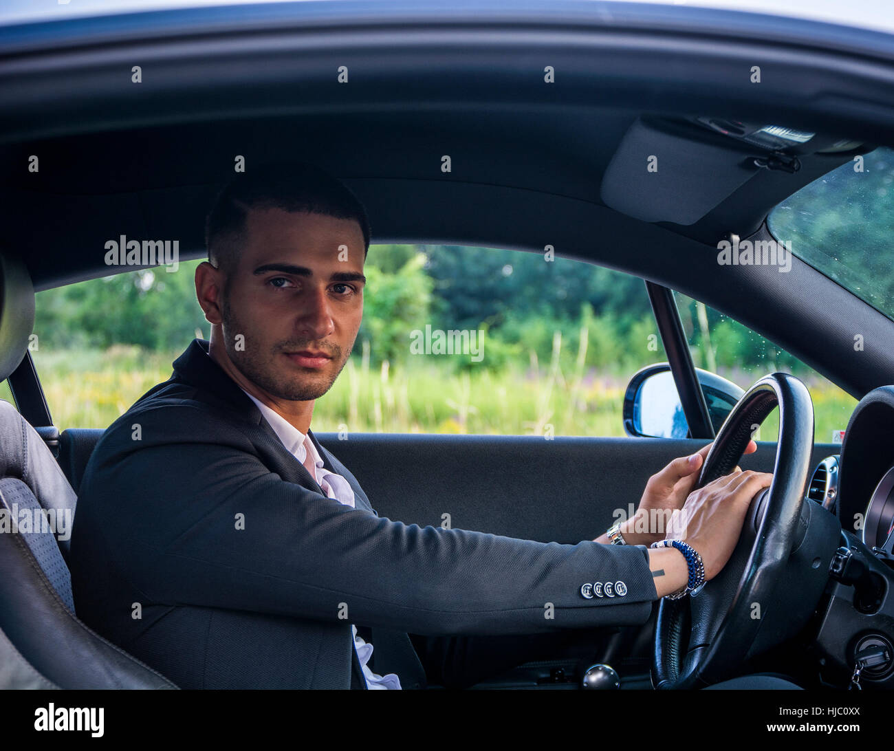 Handsome Young Man Driving a Car Stock Photo - Alamy