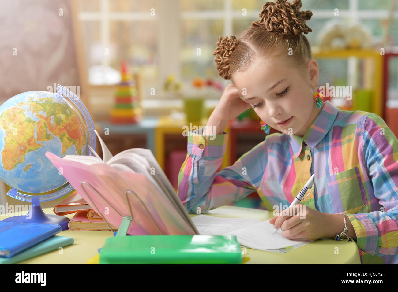 cute little girl doing lessons Stock Photo - Alamy