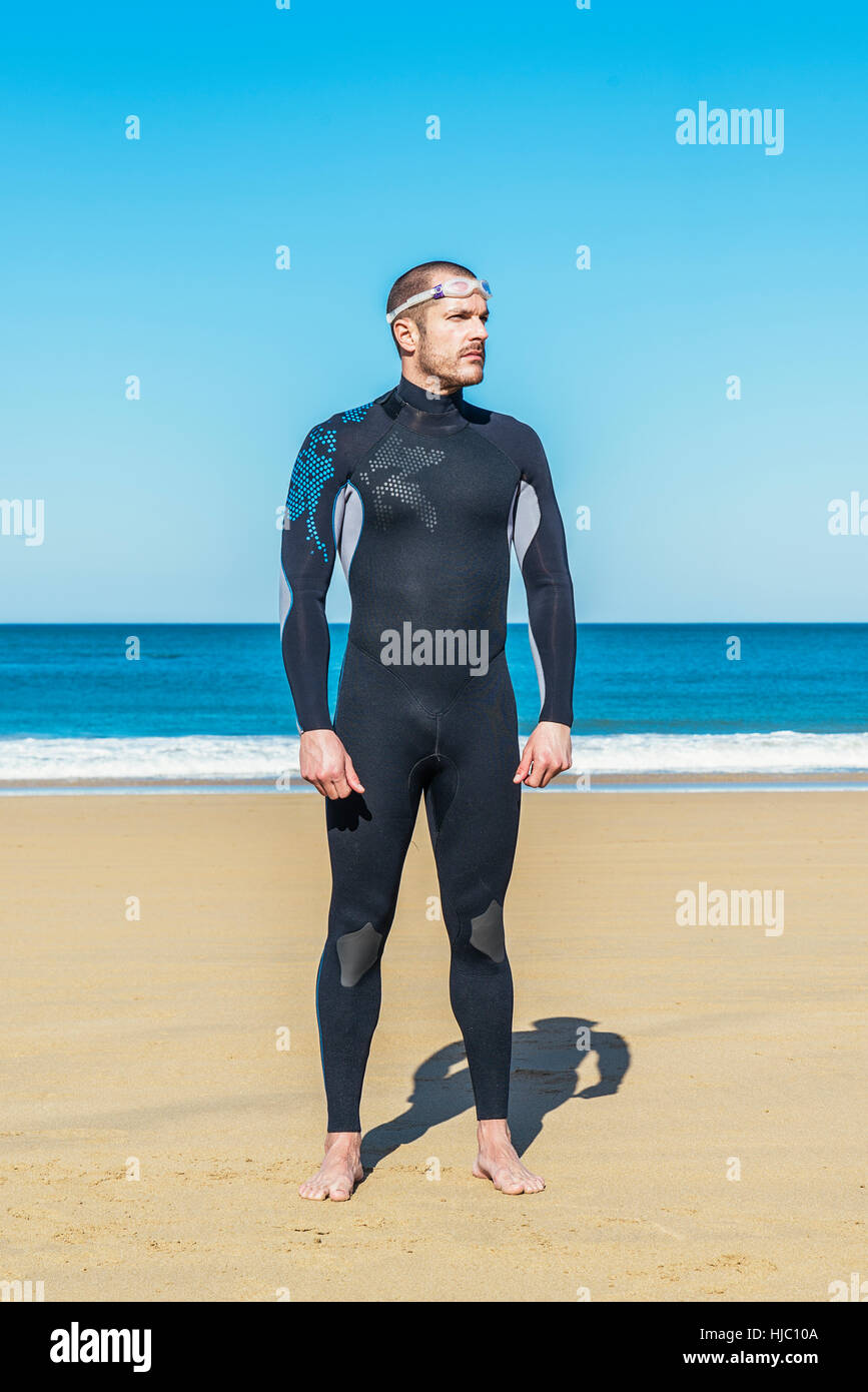 Handsome Swimmer ready to start swimming on the beach Stock Photo - Alamy