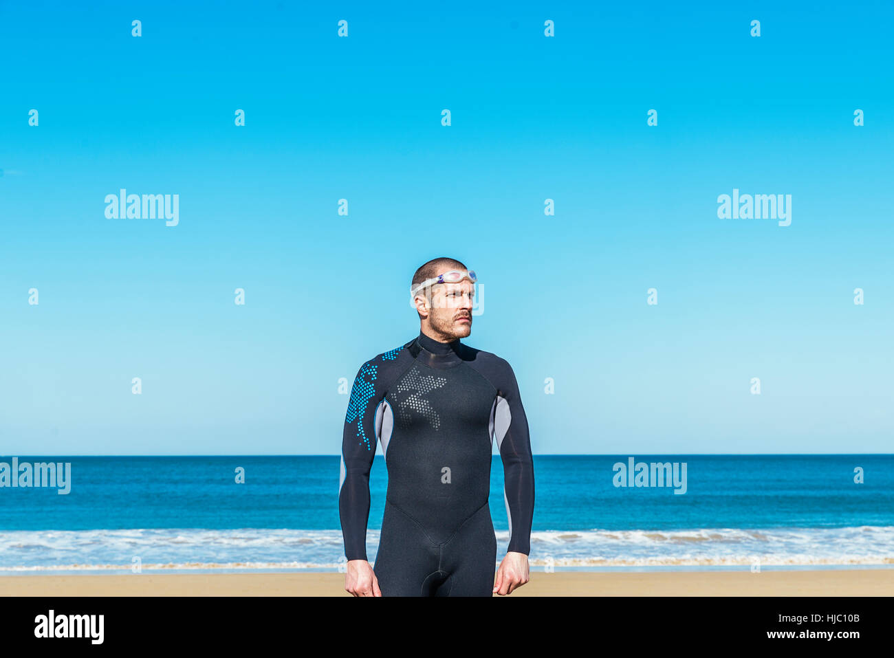 Handsome Swimmer ready to start swimming on the beach Stock Photo - Alamy