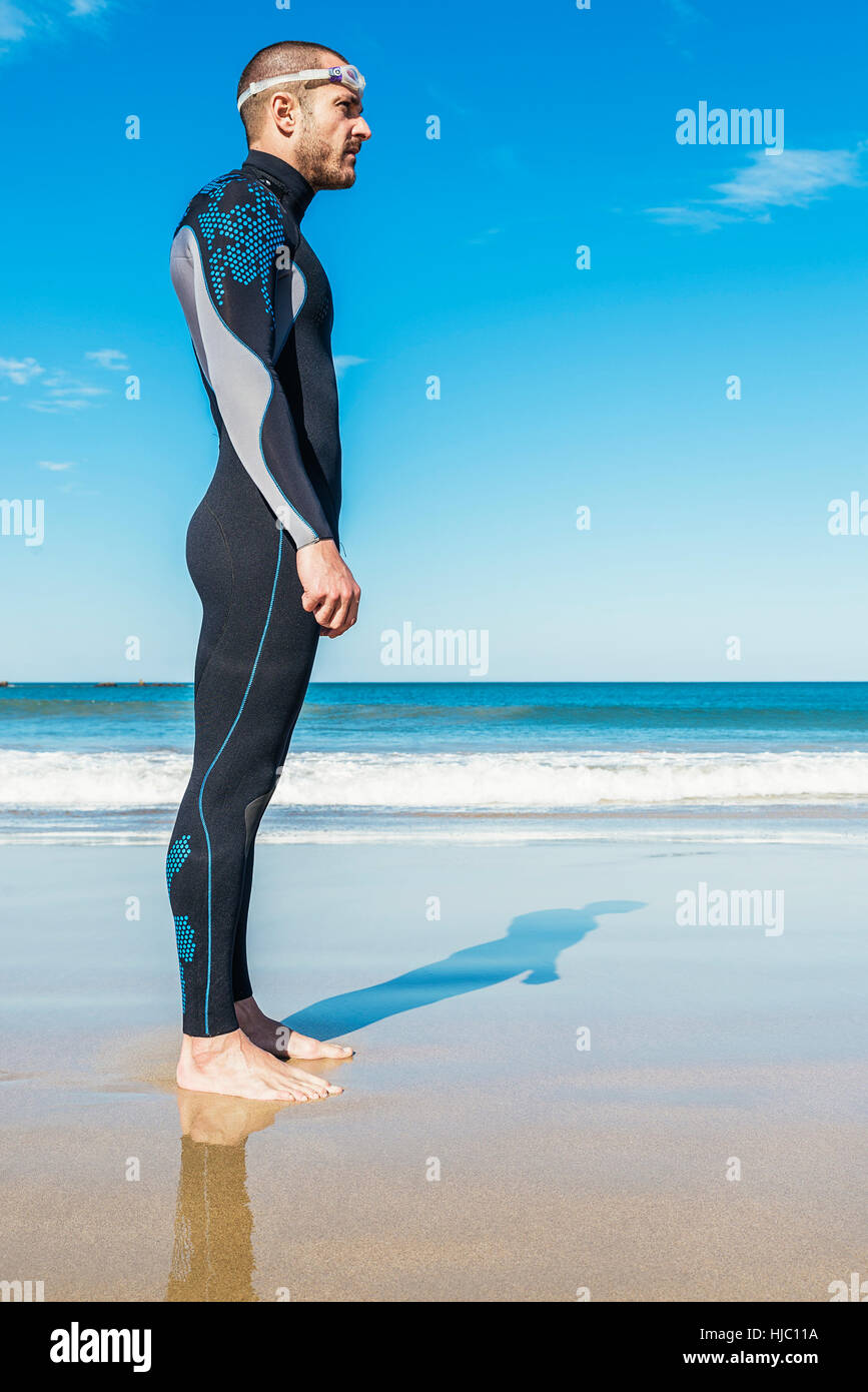 Handsome Swimmer ready to start swimming on the beach Stock Photo - Alamy