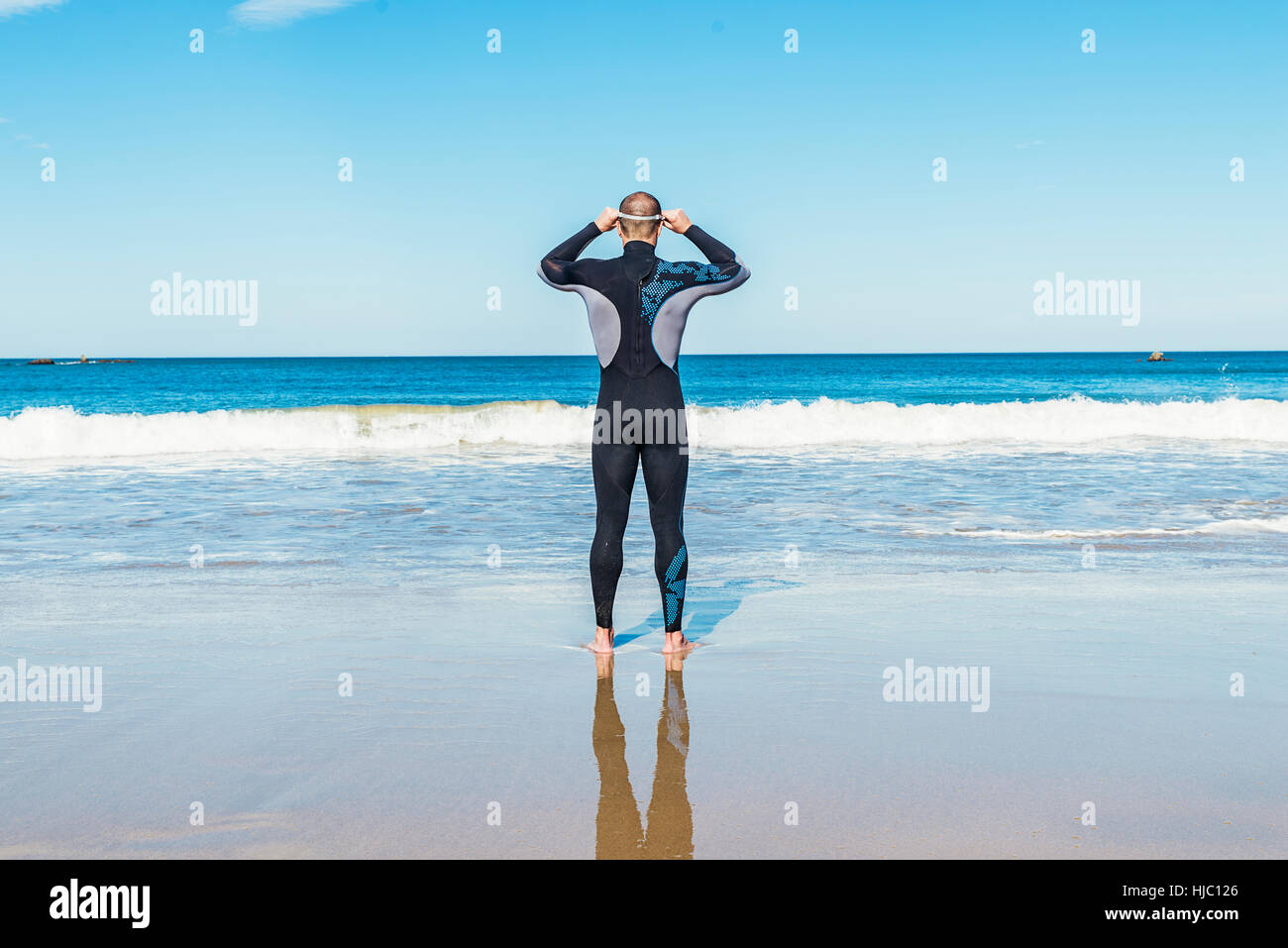 Handsome Swimmer ready to start swimming on the beach Stock Photo - Alamy