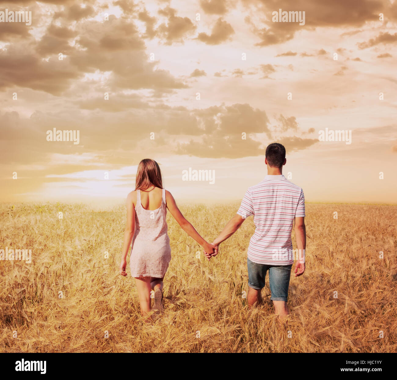 Young Couple Holding Hands Walking Away