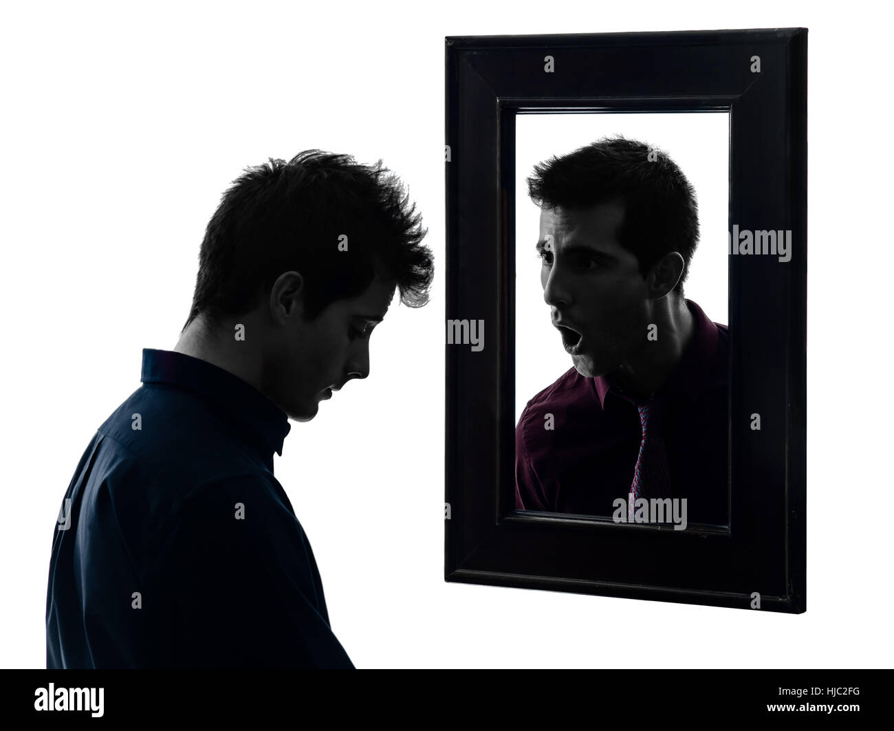 man in front of his mirror in shadow white background Stock Photo - Alamy