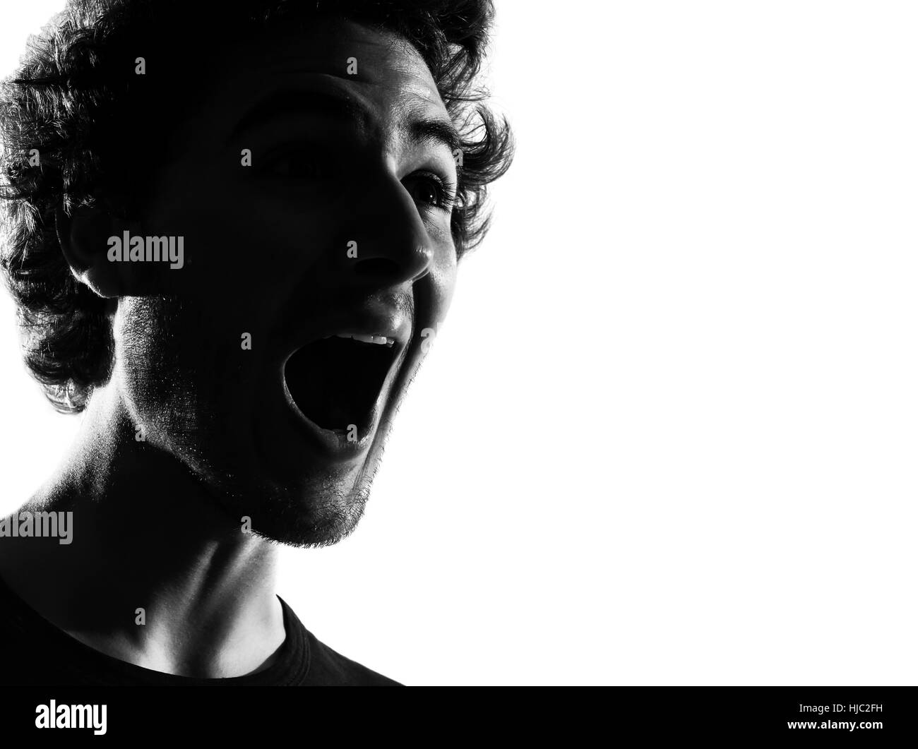 young man happy screaming silhouette in studio isolated on white ...