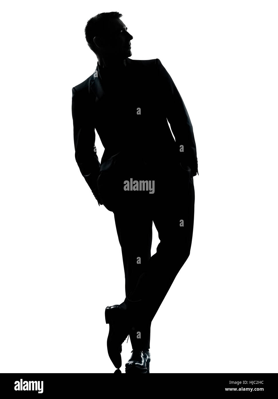 one caucasian business man silhouette standing Full length hands in pocket in studio isolated on ...