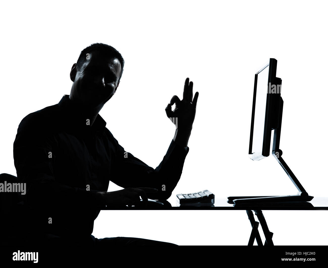 one caucasian business man computer computing ok gesture silhouette in ... one caucasian business man computer computing ok gesture silhouette in ...
