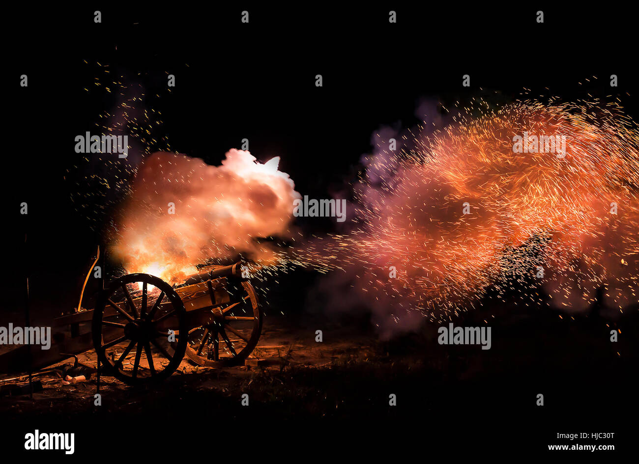 Cannon blast with sparkles flying out Stock Photo - Alamy