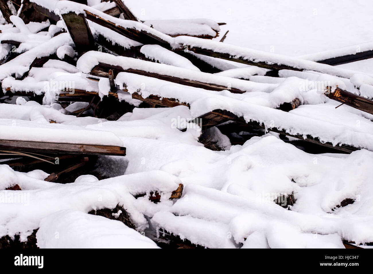 Pile of wooden rubble covered in snow Stock Photo - Alamy