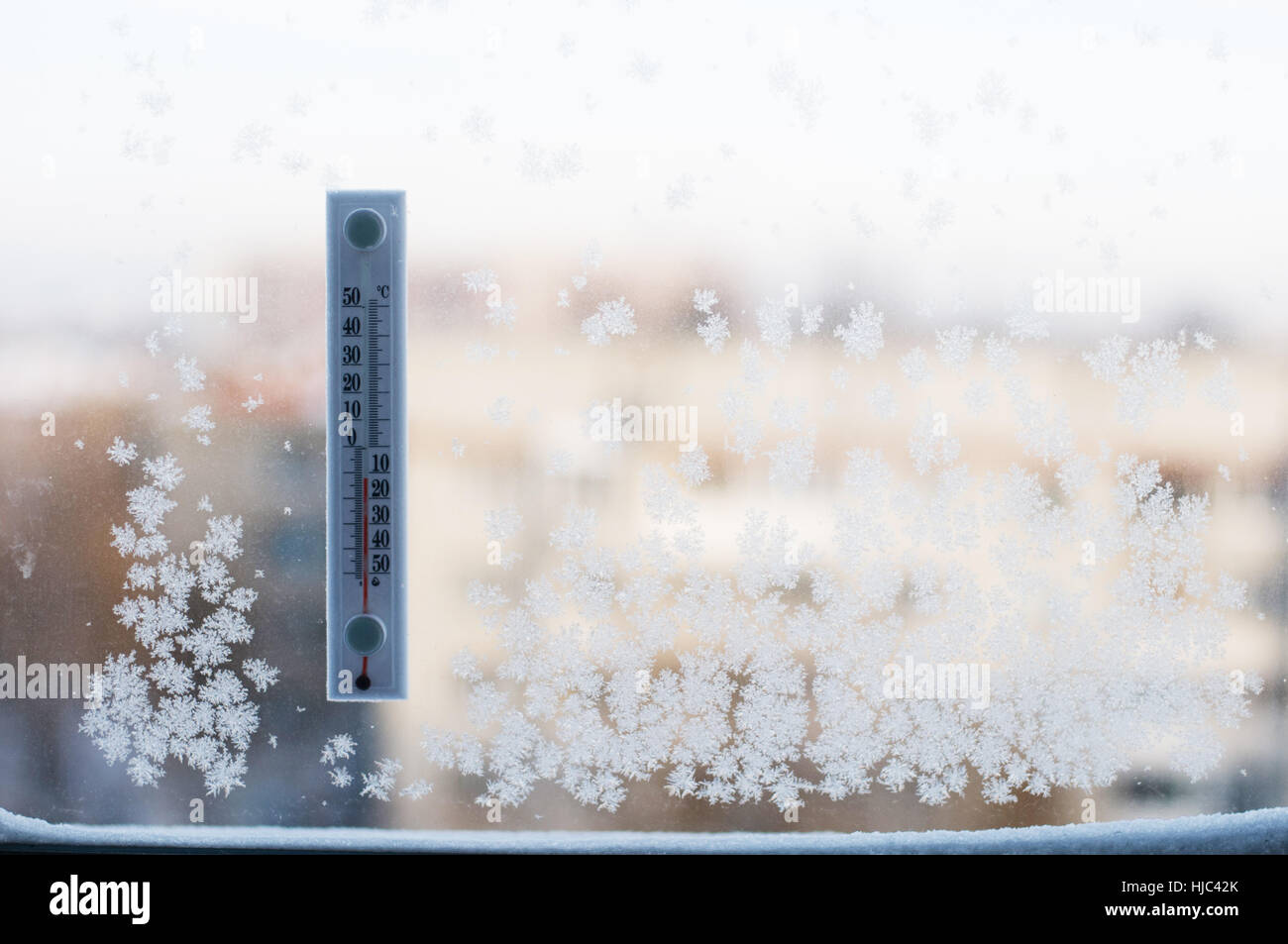 thermometer on winter window with frosts look through. Minus ten ...