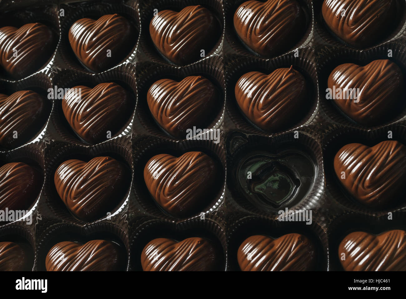 Box of heart-shaped chocolate, one candy empty, sweets background Stock ...