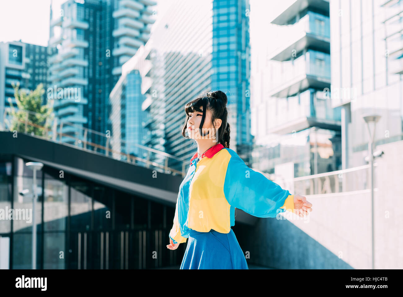 Young woman with arms wide open outdoor in the city - freedom ...