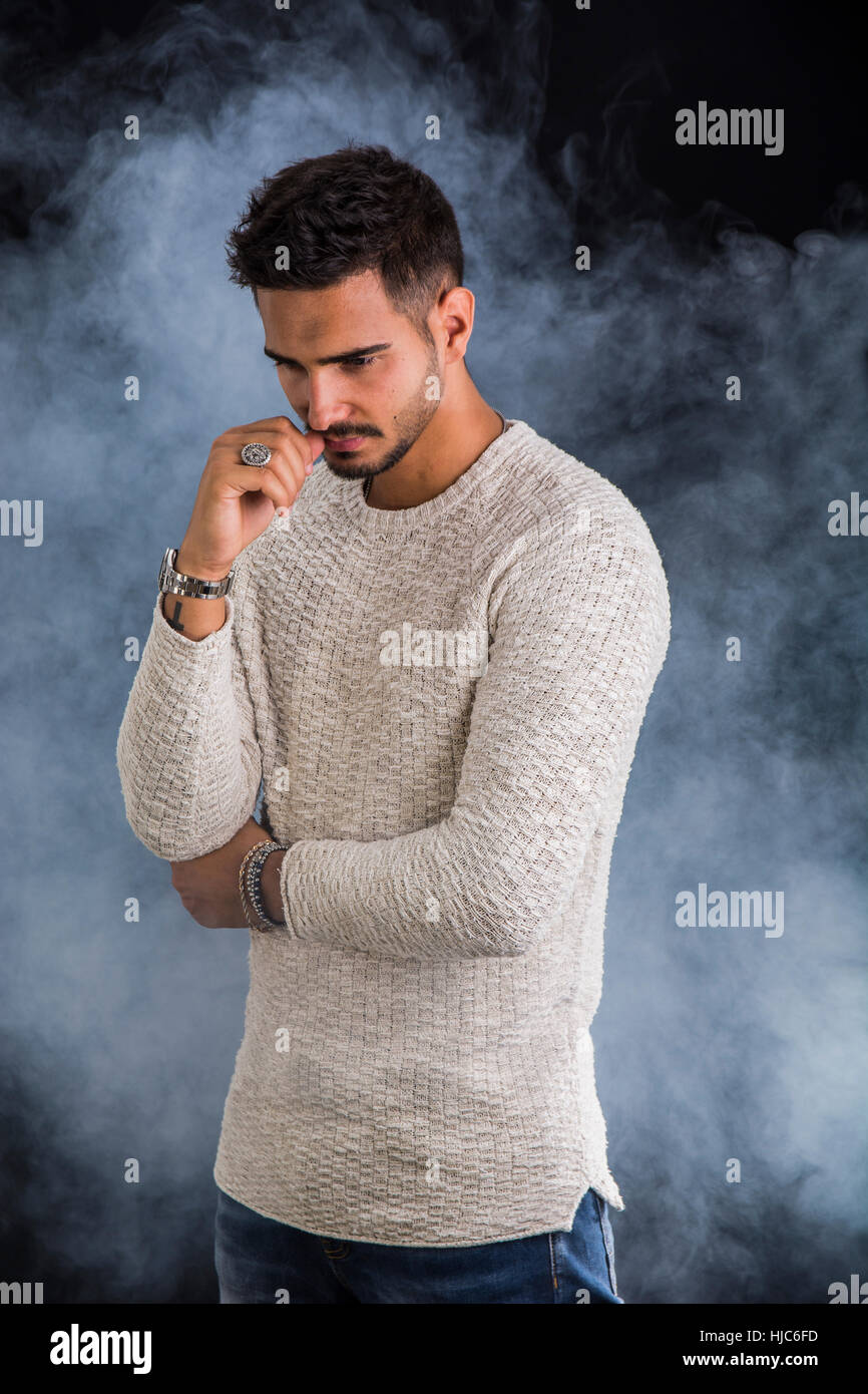 Handsome young man wearing white sweater Stock Photo - Alamy