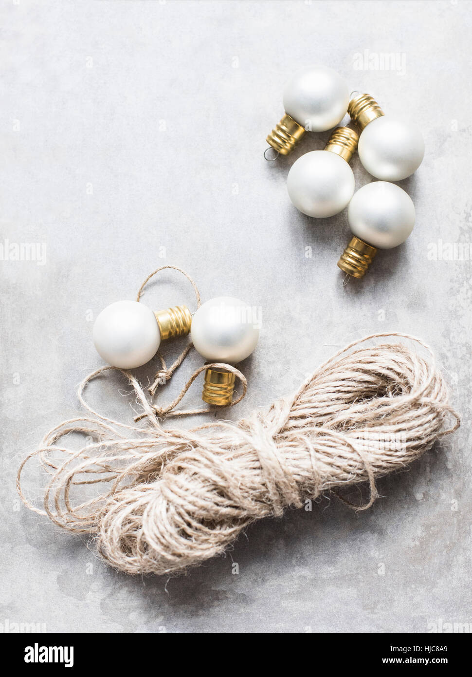Overhead view of white Christmas baubles with string Stock Photo - Alamy