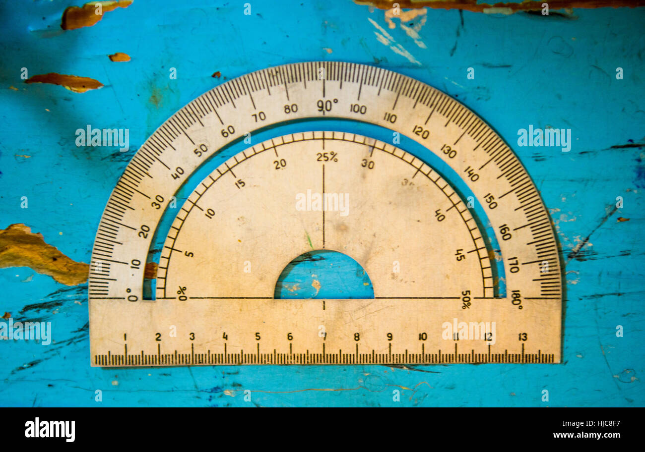 Overhead view of vintage protractor on blue table Stock Photo - Alamy