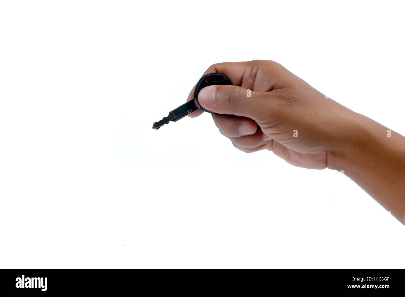 male hand holding a key isolated on white background Stock Photo - Alamy