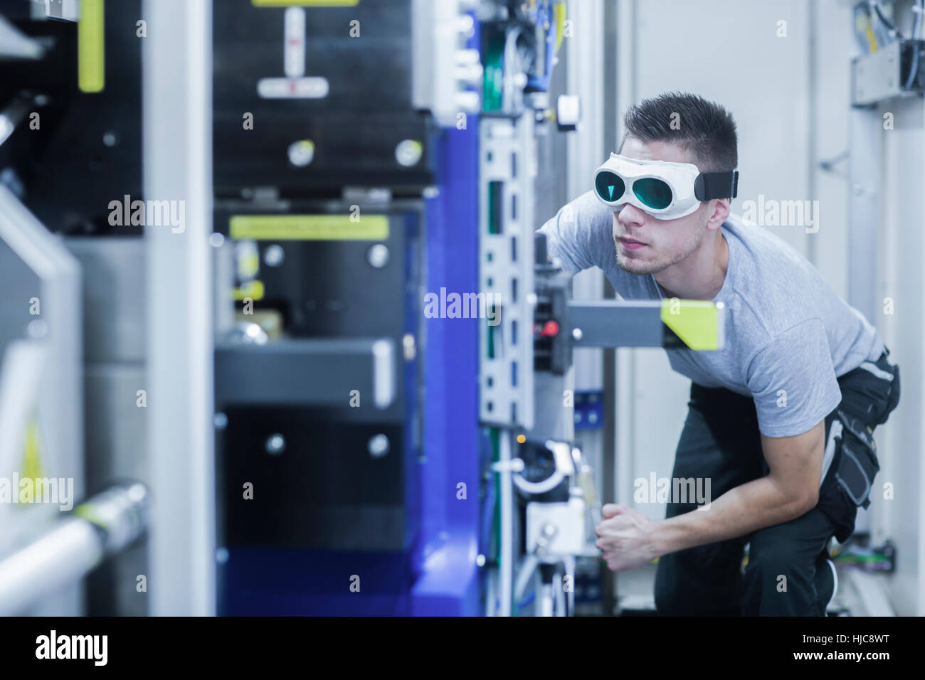 Engineer, wearing safety goggles, working in engineering plant Stock ...
