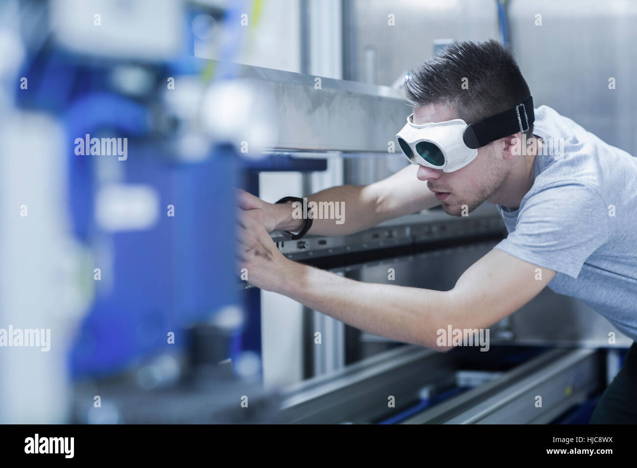 Engineer, wearing safety goggles, working in engineering plant Stock ...