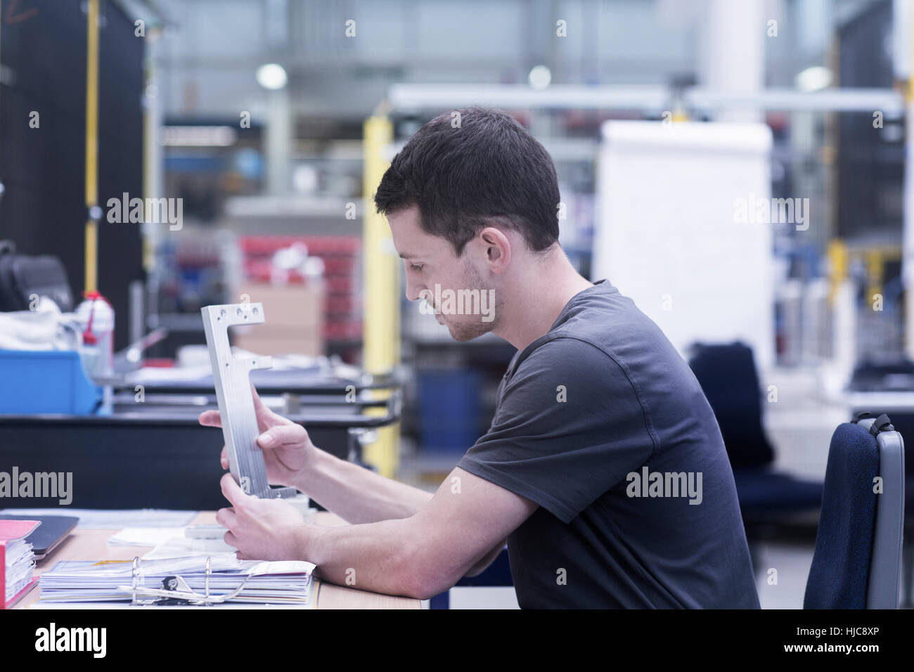 Engineer working on metal rail in engineering plant Stock Photo - Alamy