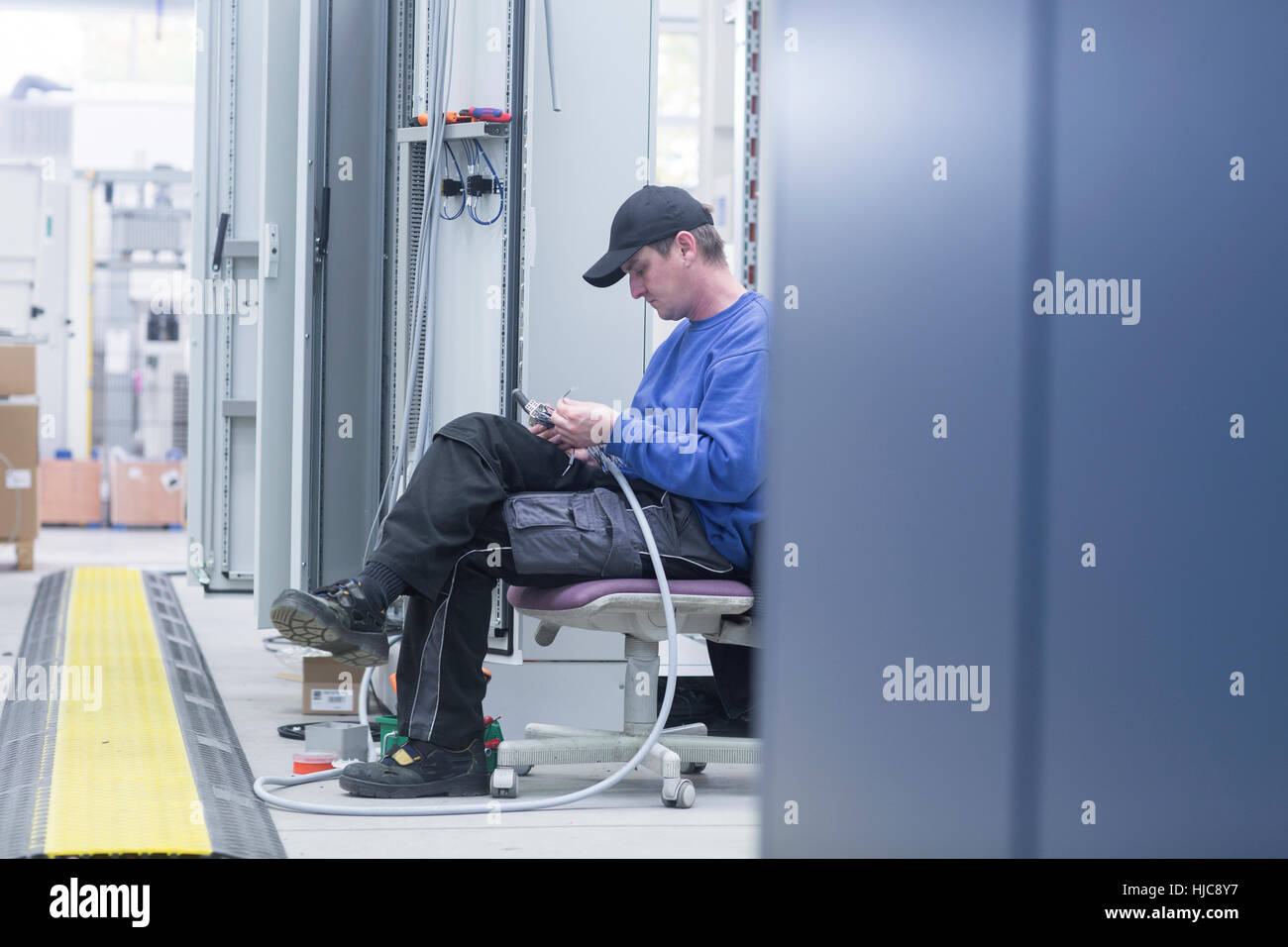 Engineer working with electrical components in engineering plant Stock ...