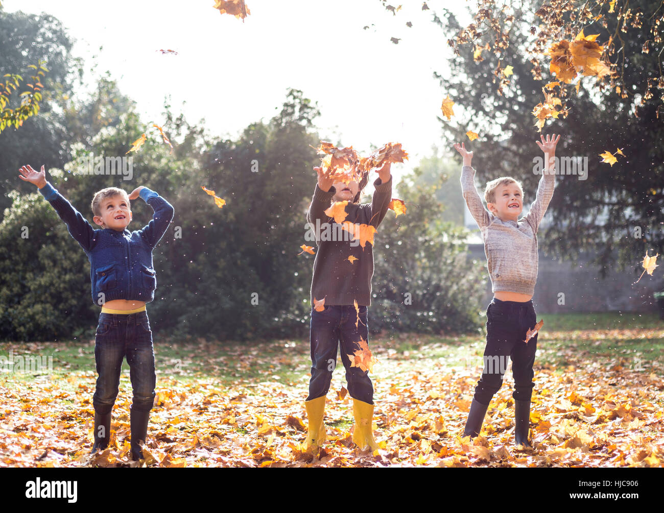 Children throwing autumn leaves hi-res stock photography and images - Alamy