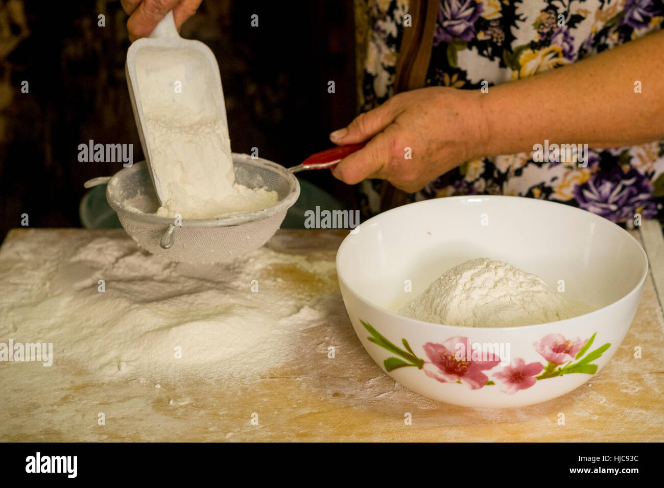 Woman sieving flour at table, mid section Stock Photo - Alamy