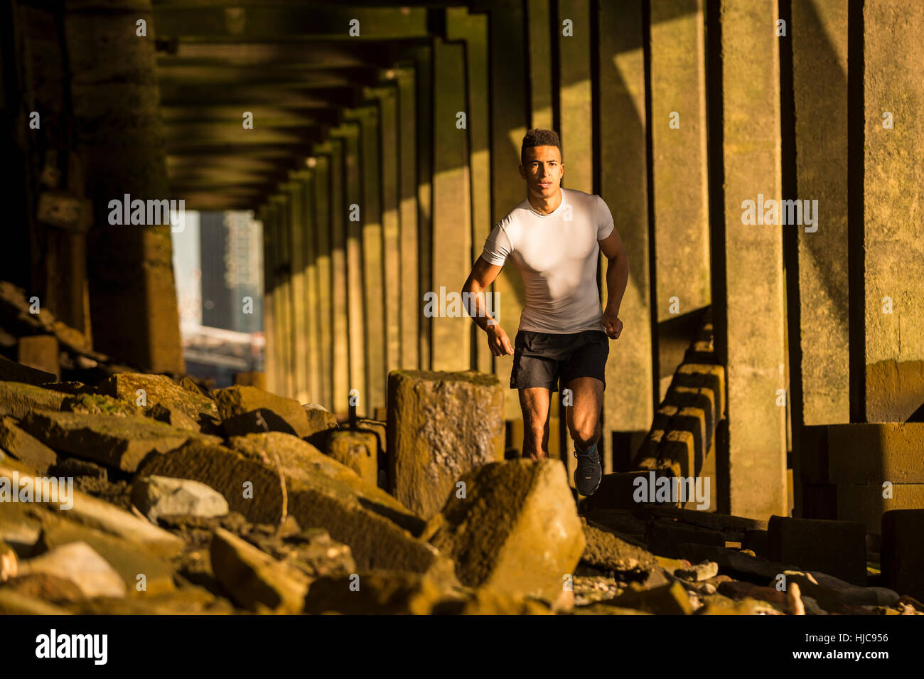 Man running under bridge, Wapping, London, UK Stock Photo - Alamy