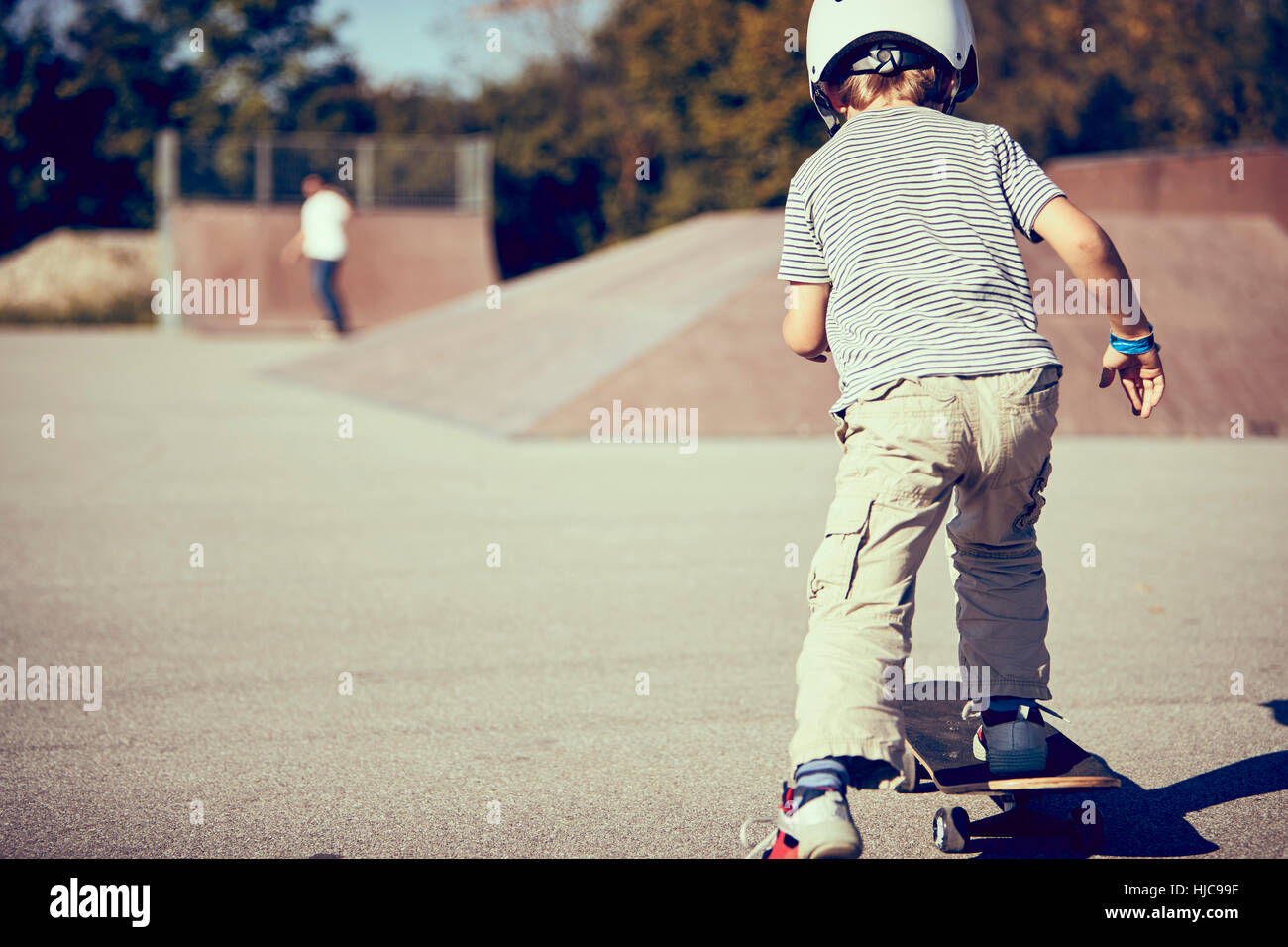 Boy skateboarding in park Stock Photo - Alamy