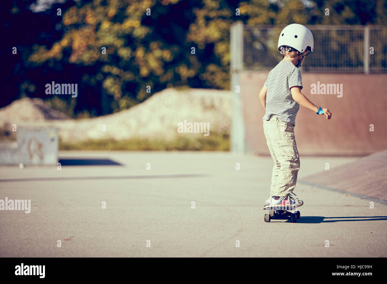 Boy skateboarding in park Stock Photo - Alamy